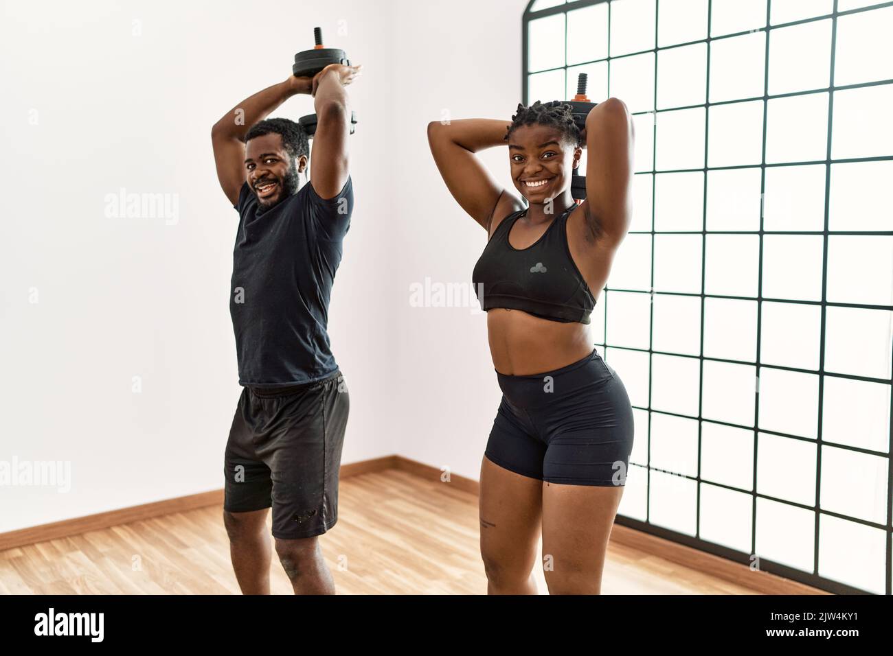 Young african american sporty couple training power exercise using ...