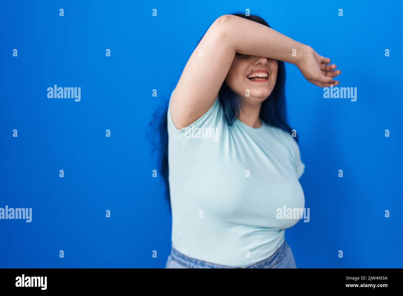 Young Modern Girl With Blue Hair Standing Over Blue Background Covering 6313