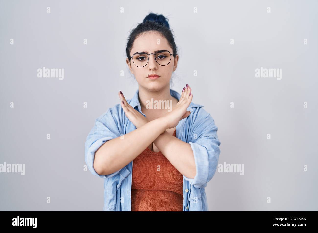 Young modern girl with blue hair standing over white background ...