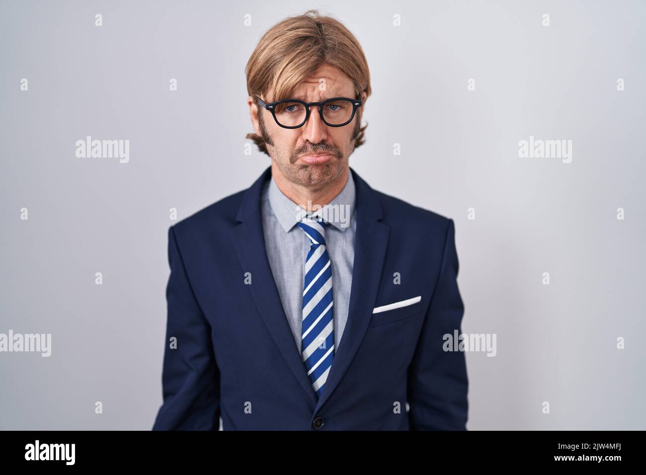 Caucasian man with mustache wearing business clothes depressed and ...