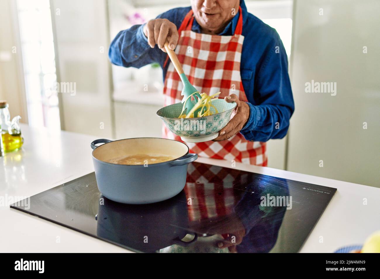Senior man cooking spaghetti at kitchen Stock Photo - Alamy