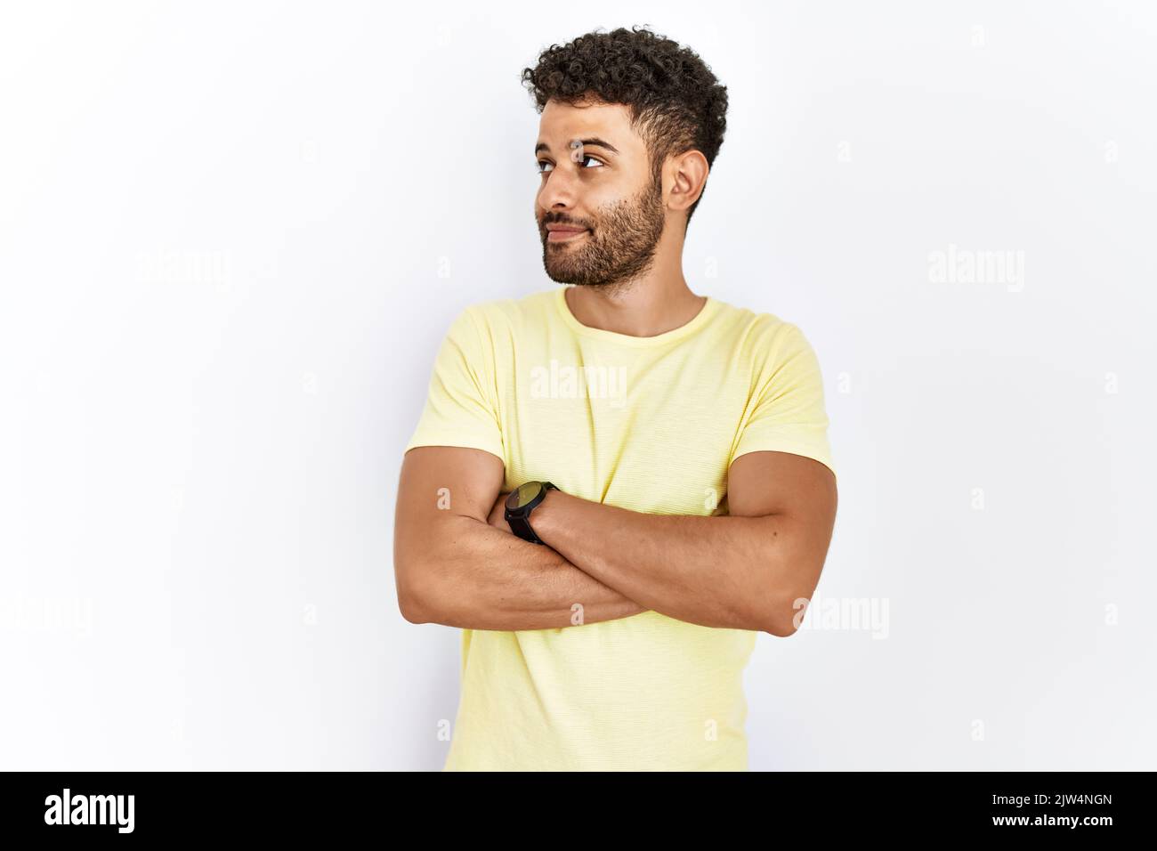 Arab young man standing over isolated background smiling looking to the ...