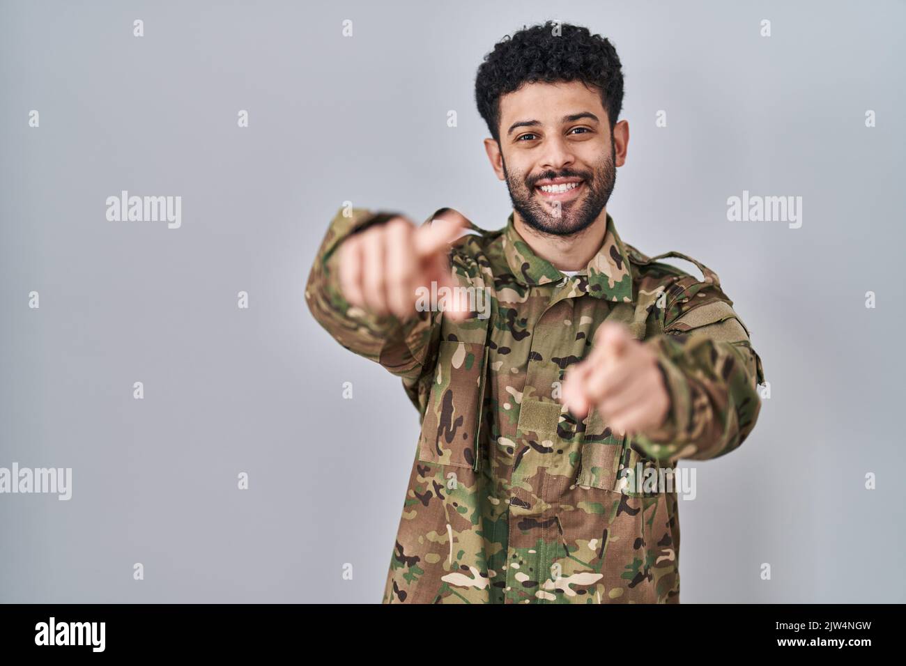 Arab man wearing camouflage army uniform pointing to you and the camera ...