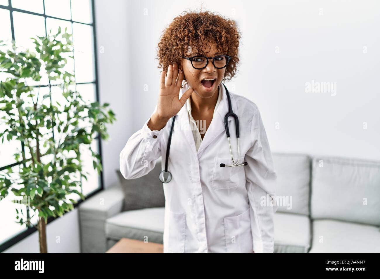 Young african american woman wearing doctor uniform and stethoscope ...