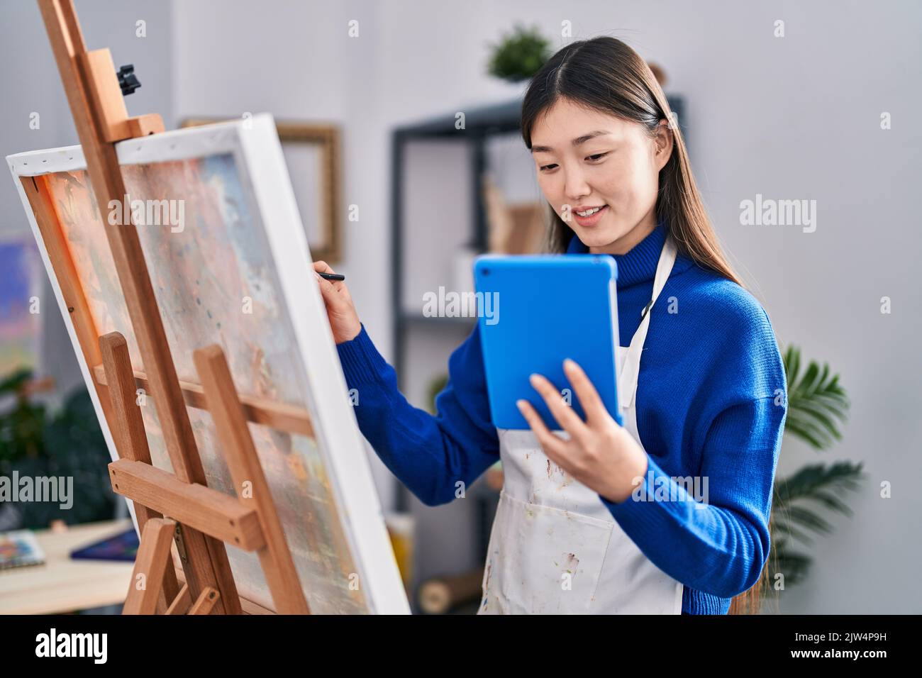 Chinese woman artist using touchpad drawing at art studio Stock Photo ...