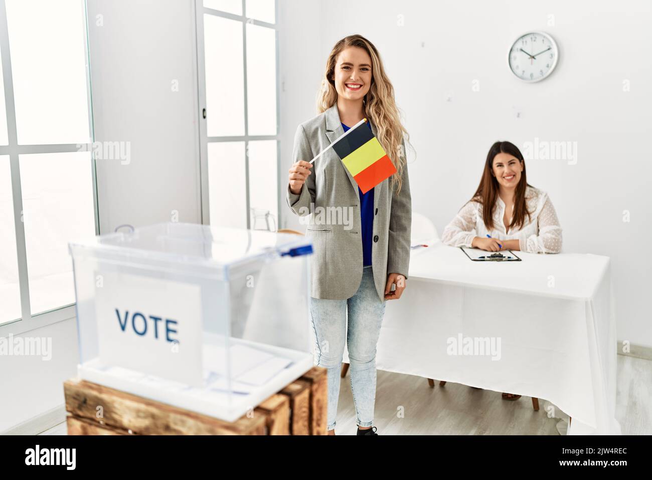 Young belgian voter woman smiling happy holding belgium flag at ...