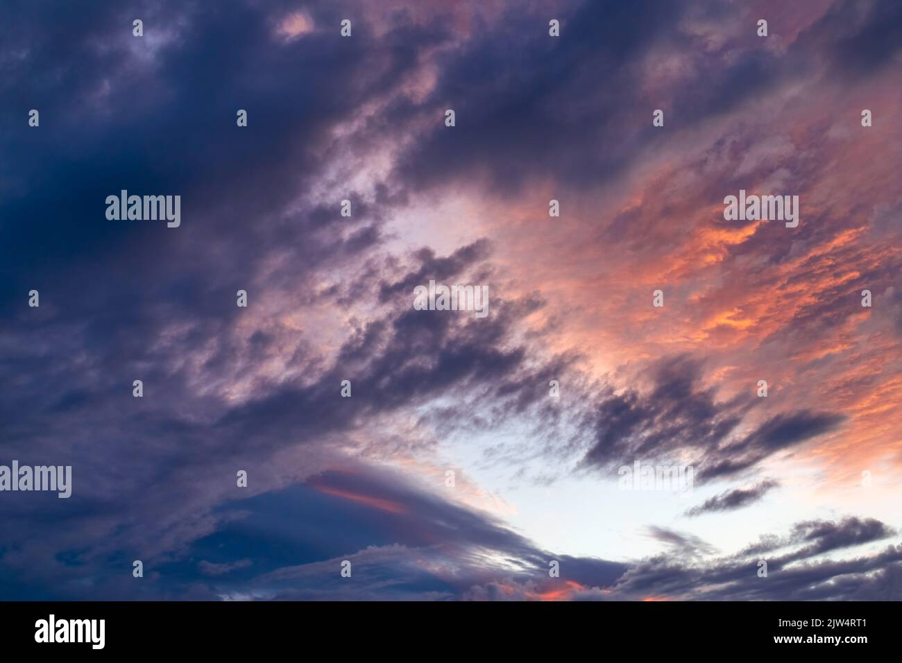 Evening sky in the picturesque clouds, lit by the rays of the setting ...