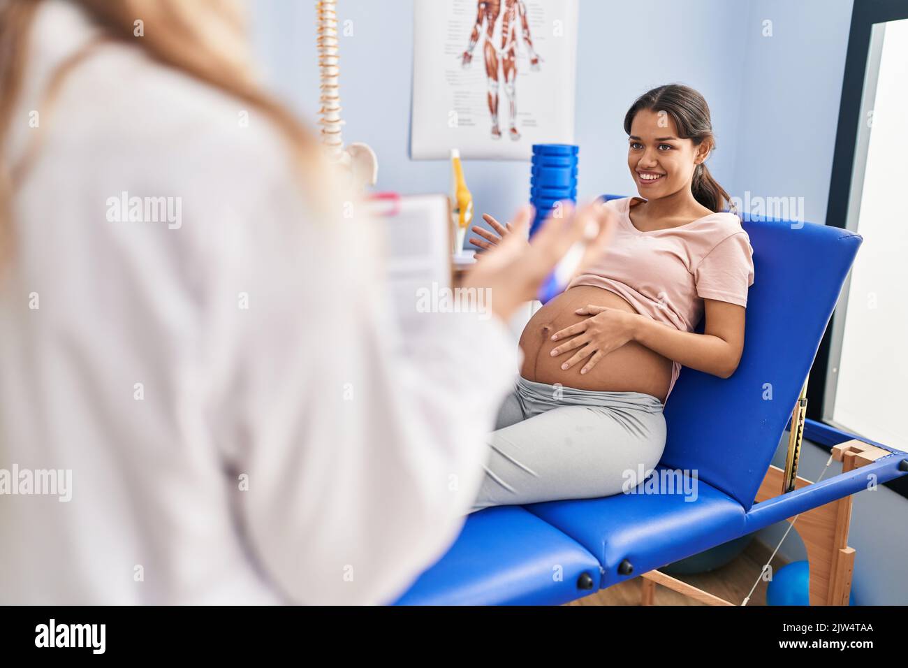 Young latin woman pregnant patient having physiotherapy session at ...