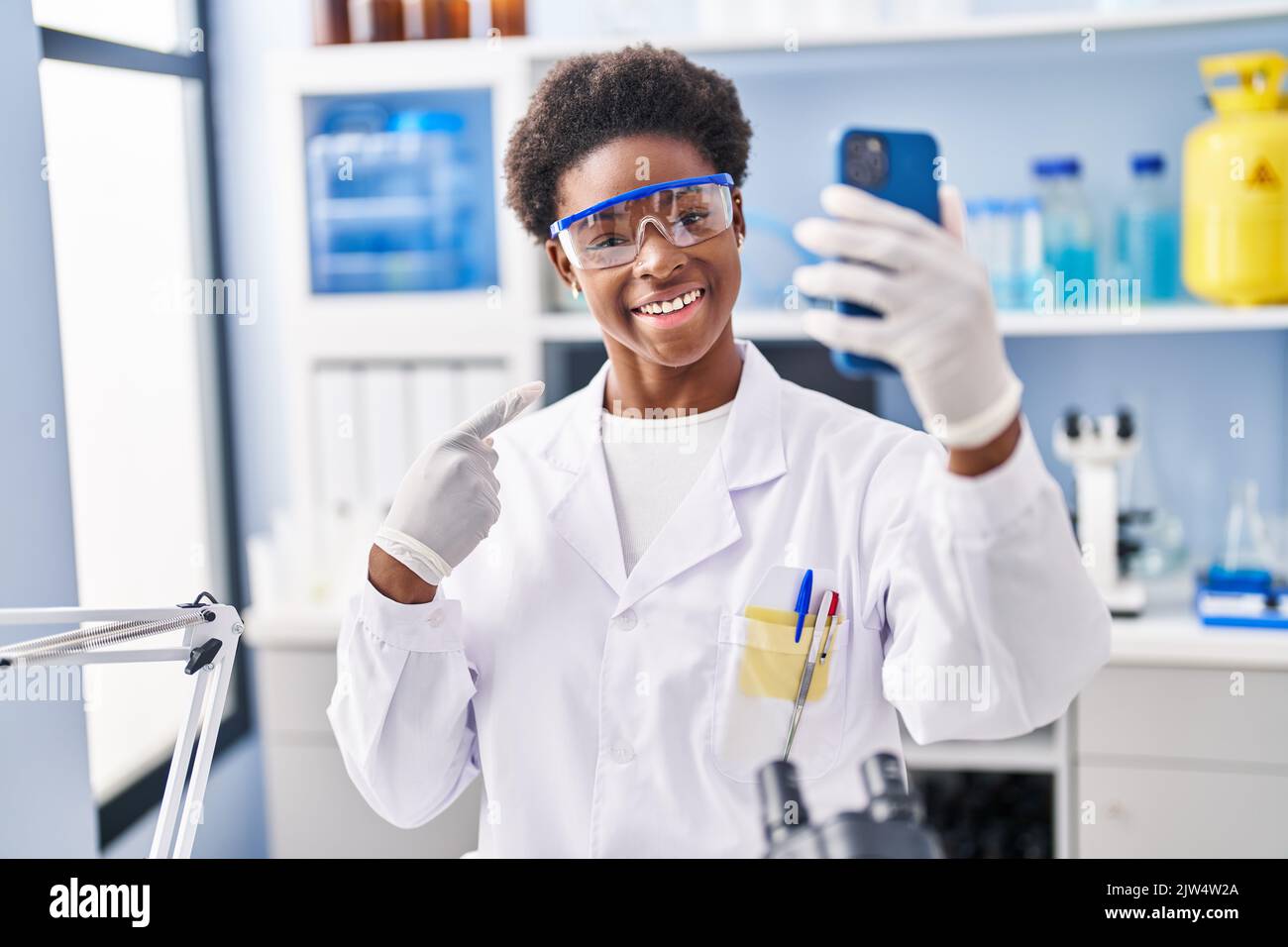 African american woman working at scientist laboratory doing video call ...