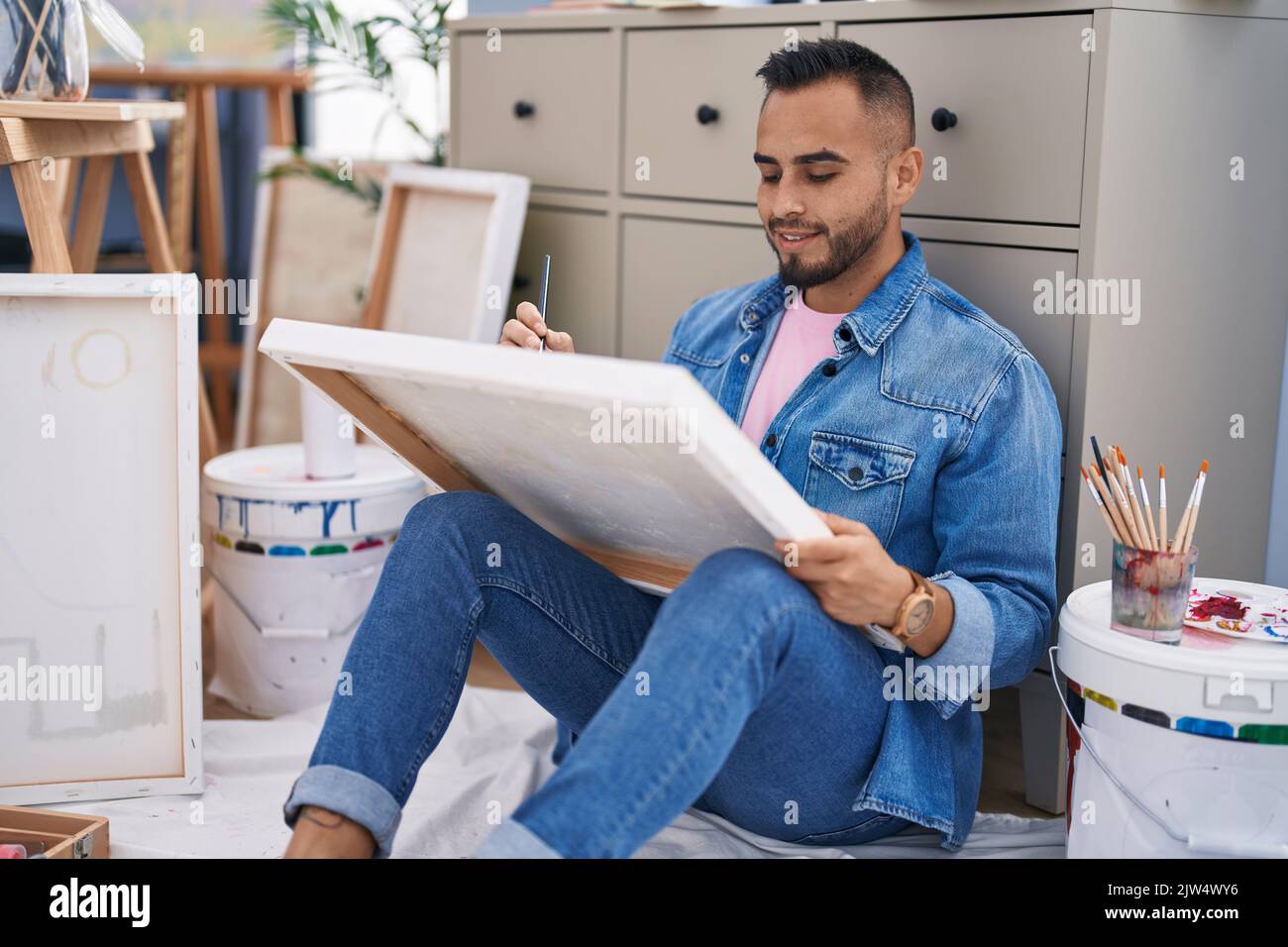 Young hispanic man artist smiling confident drawing at art studio Stock ...