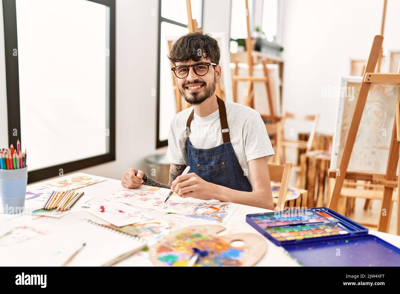 Young hispanic artist man smiling happy drawing at art studio Stock ...