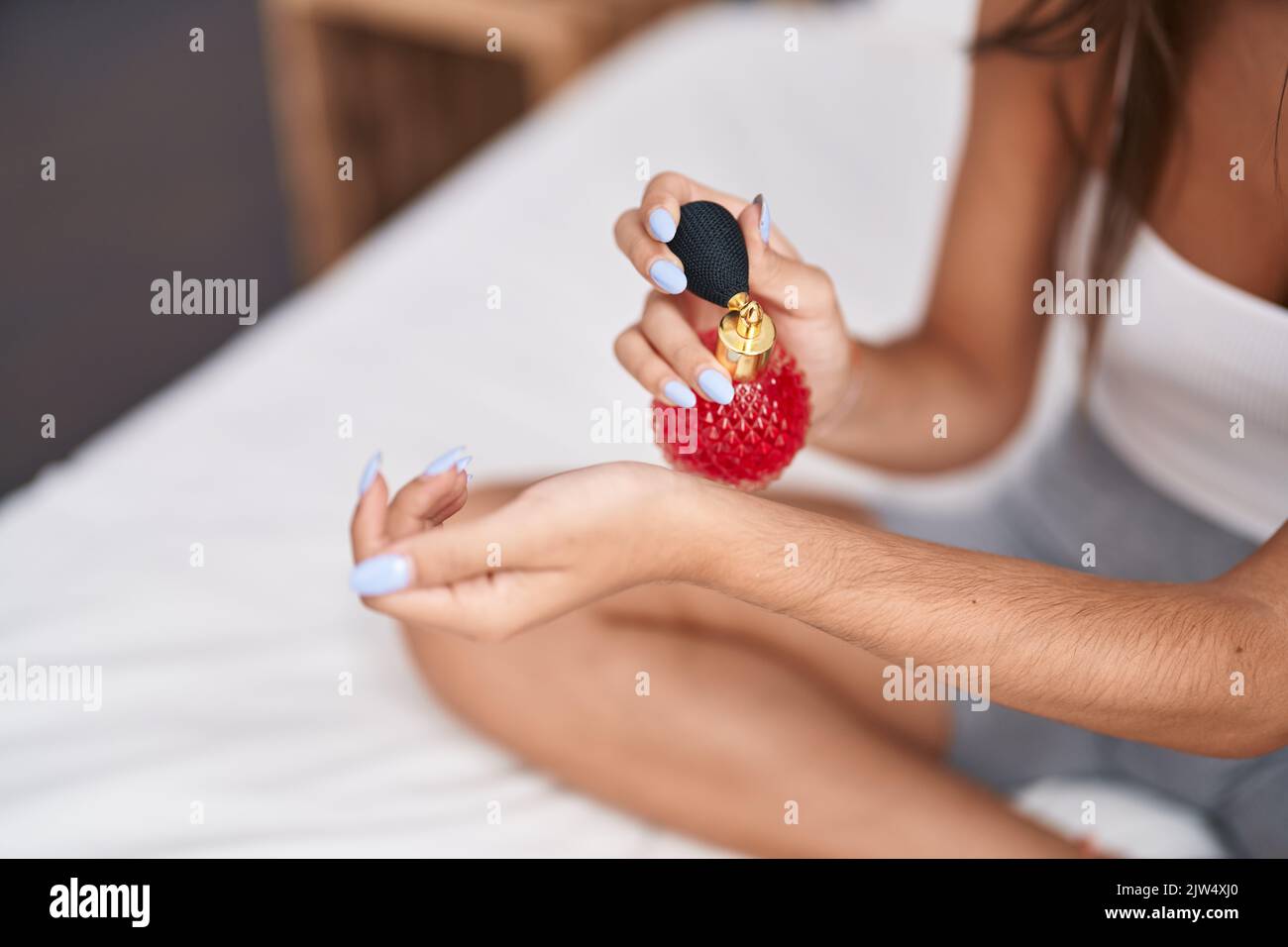 Young woman using perfume hi-res stock photography and images - Alamy