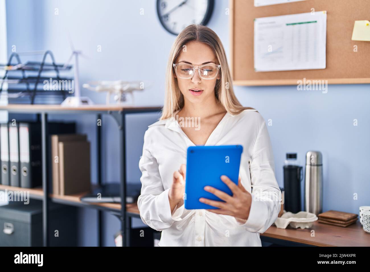 Young woman business worker using touchpad at office Stock Photo - Alamy