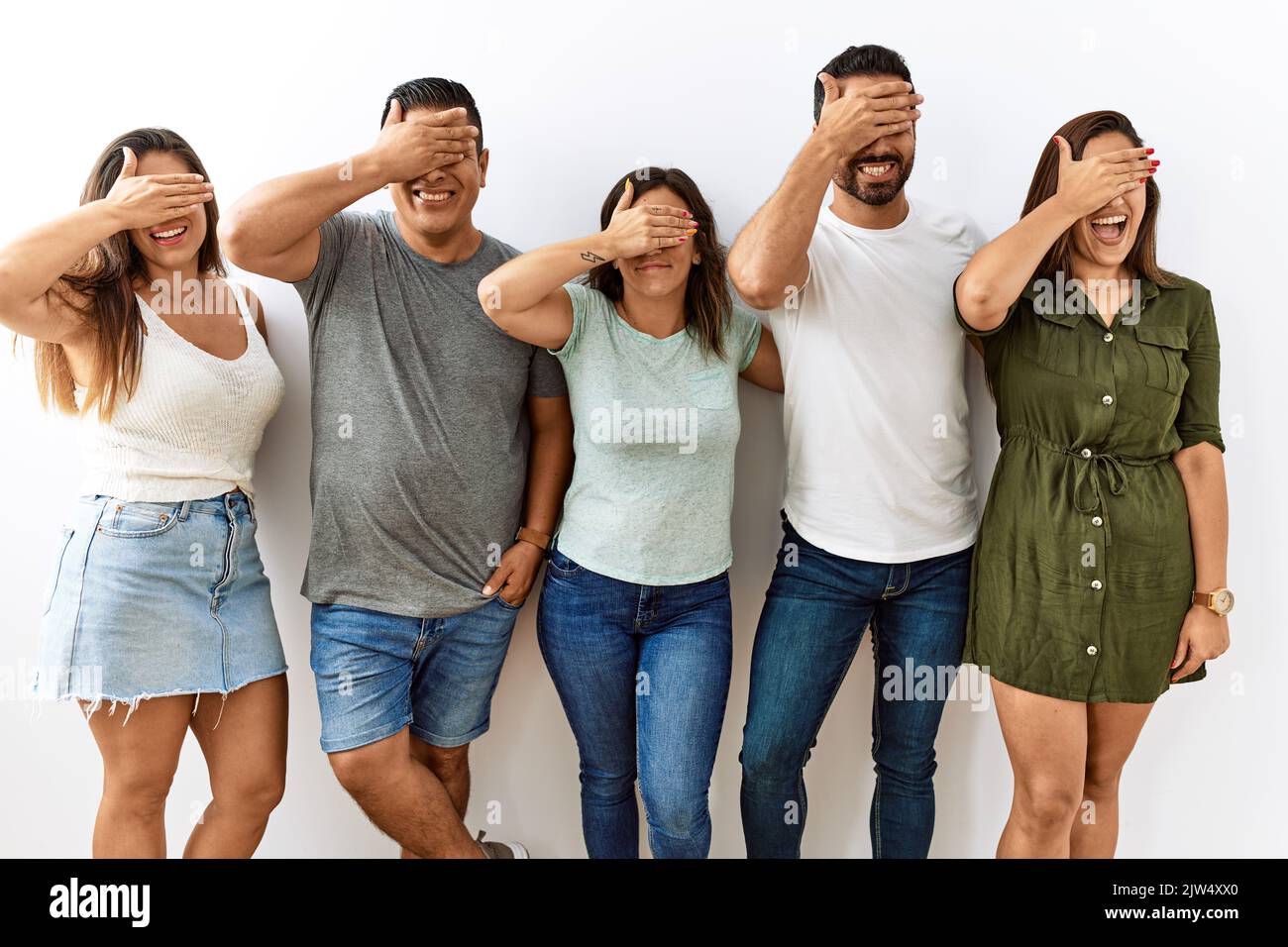 Group of young hispanic friends standing together over isolated ...