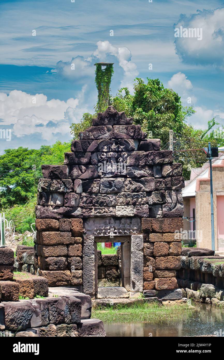 Gateway to the Prang Ku, with weathered sculpture. An ancient, ruined ...