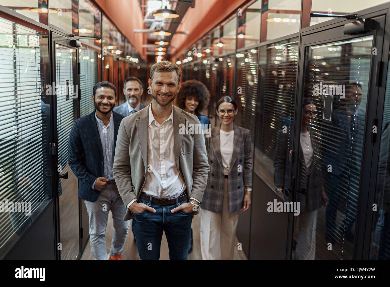 Group of happy, motivated business people standing together at office ...