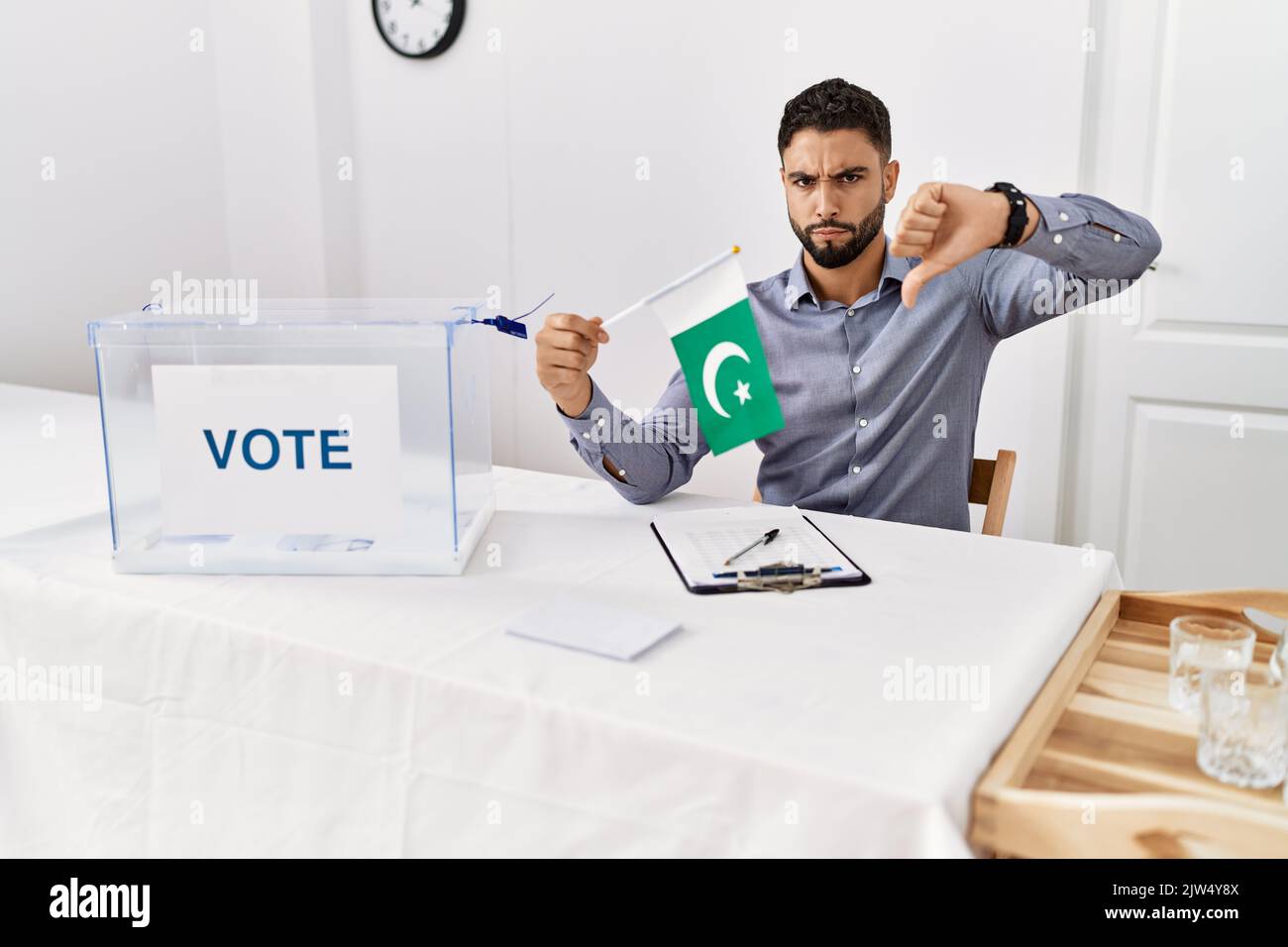 Young handsome man with beard at political campaign election holding ...