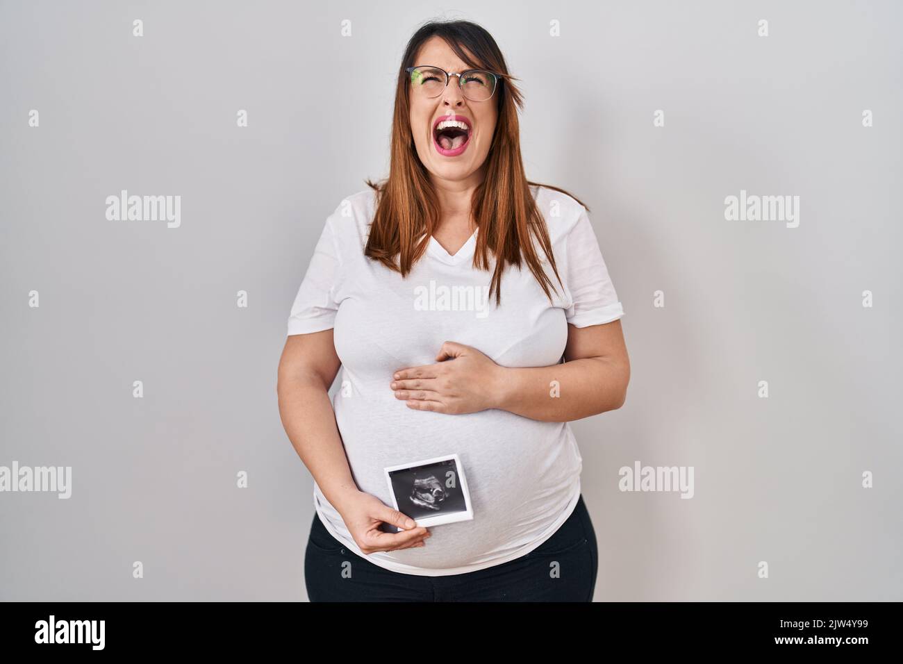 Pregnant woman holding baby ecography angry and mad screaming ...