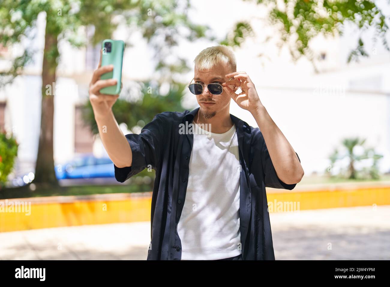 Young caucasian man making selfie by the smartphone at park Stock Photo ...