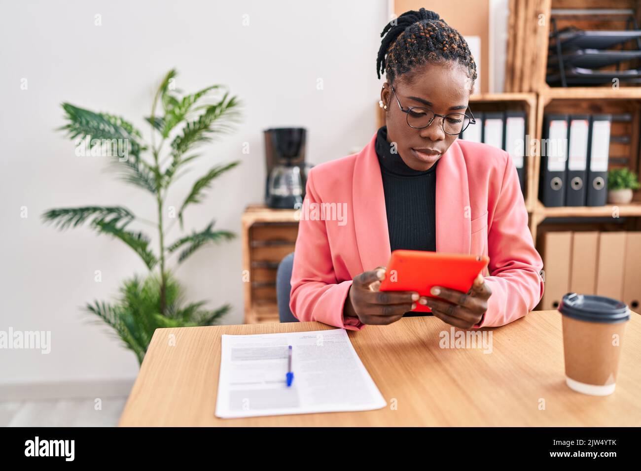 African american woman business worker using touchpad at office Stock ...