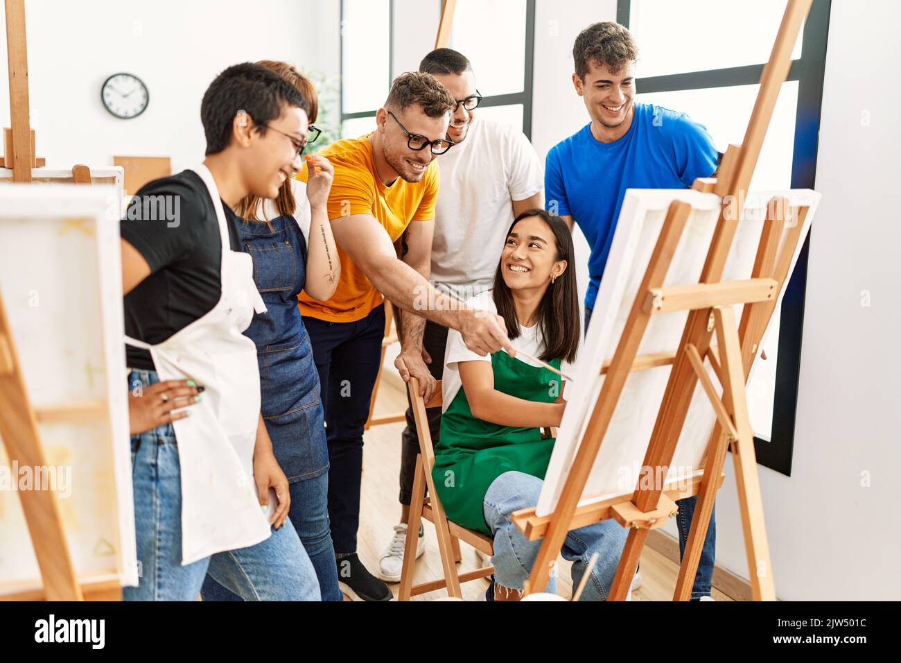 Group of people smiling happy and looking draw of partner at art studio ...