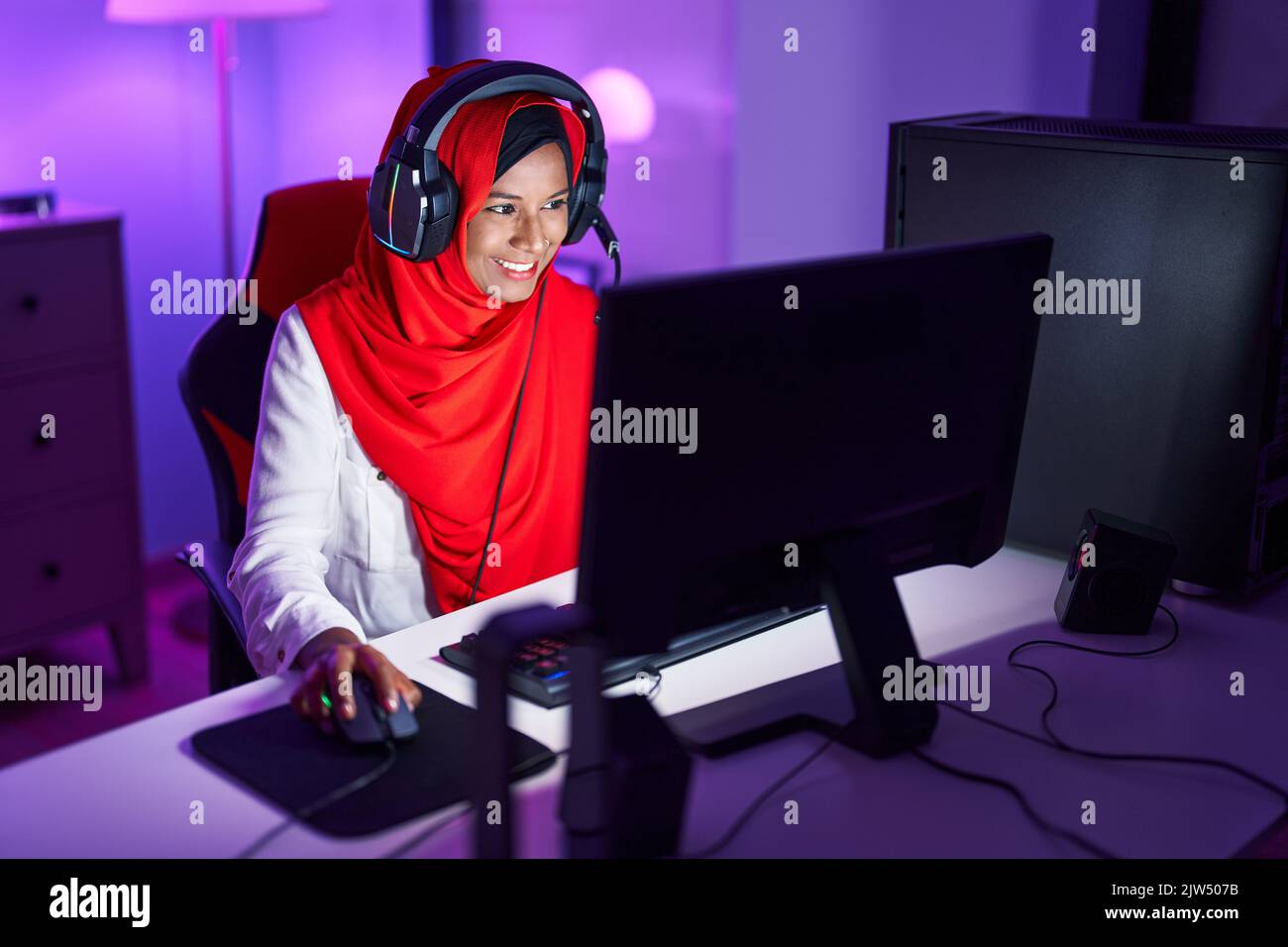 Young beautiful woman streamer playing video game using computer at ...