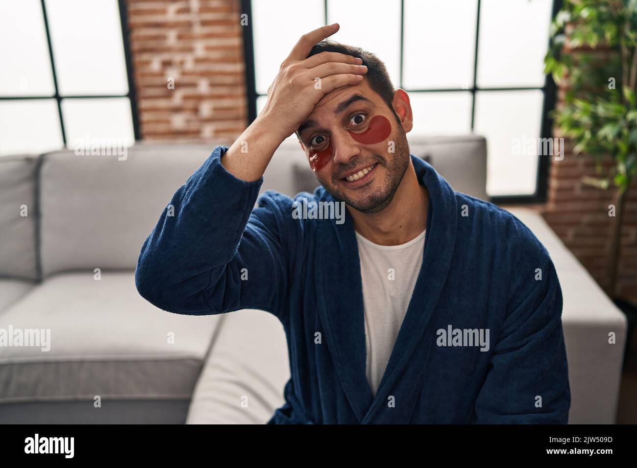 Young hispanic man with beard wearing beauty eyes patch stressed and ...