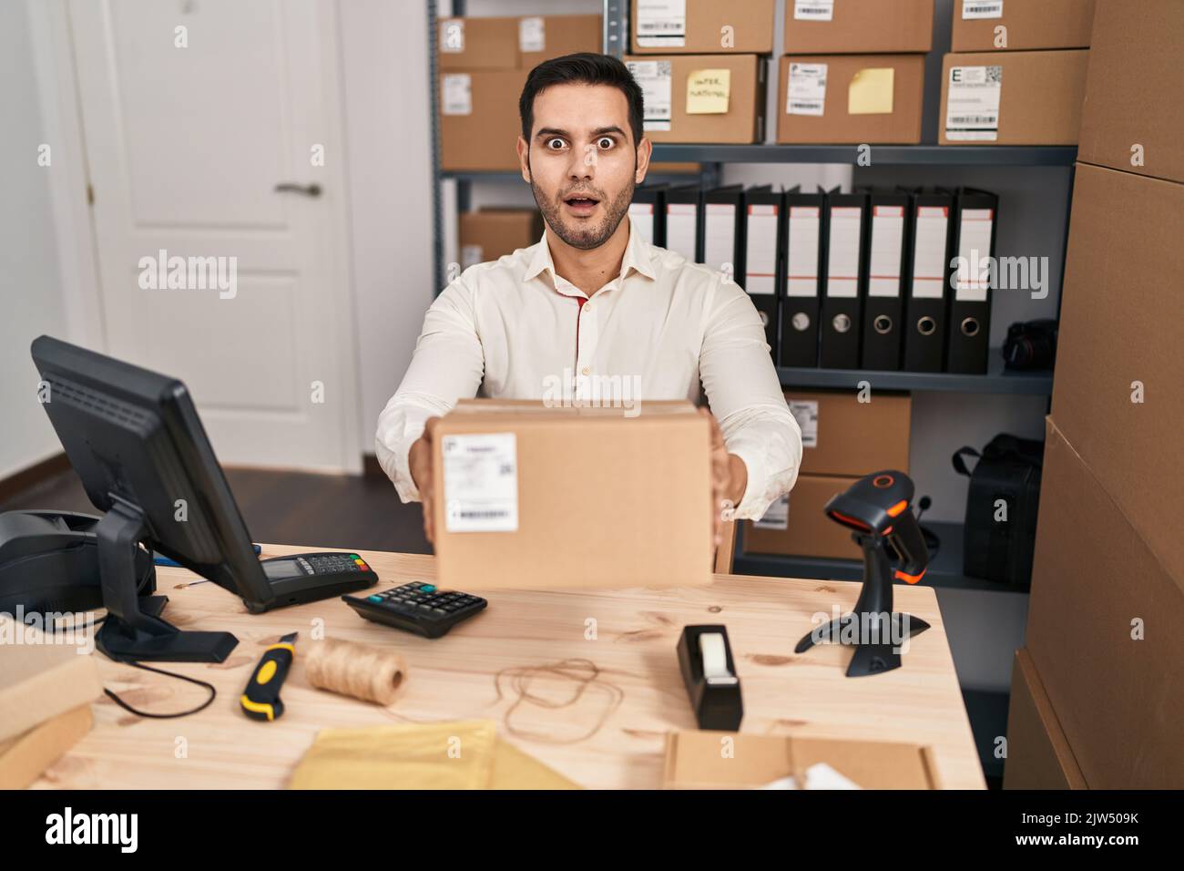 Young hispanic man with beard working at small business ecommerce ...