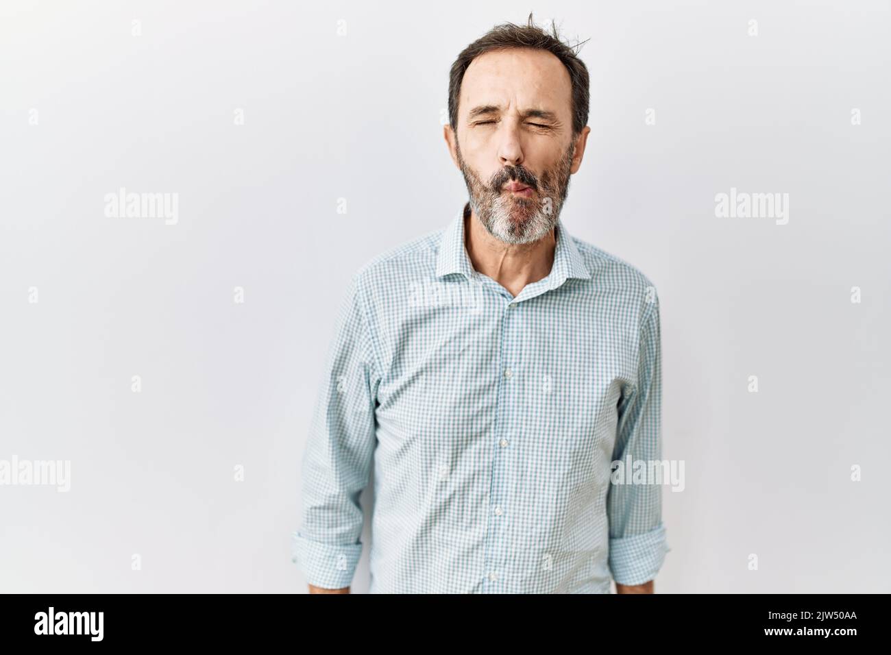 Middle age hispanic man with beard standing over isolated background ...