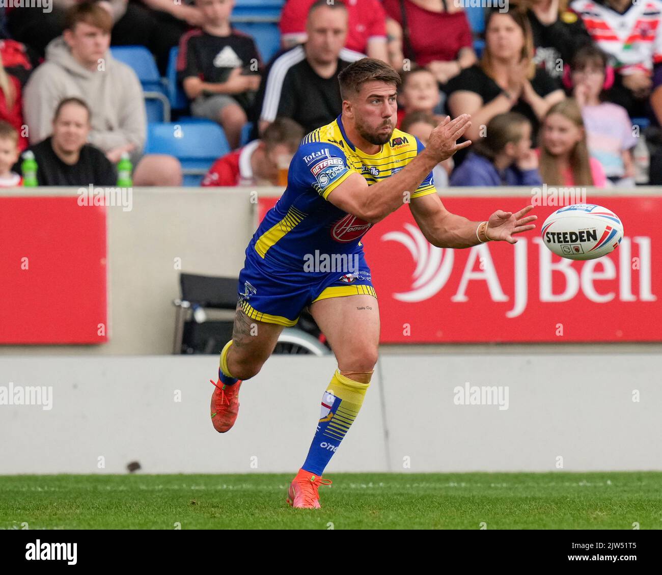 Greg Minikin #21 of Warrington Wolves passes the ball during the ...