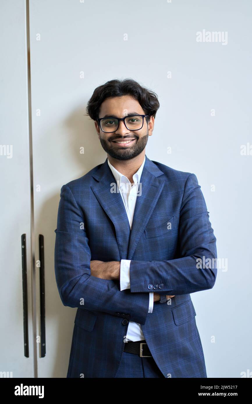 Smiling young indian business man wears suit in office, vertical ...