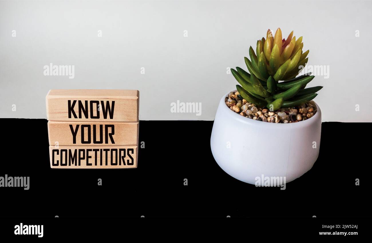 Wooden blocks with text KNOW YOUR COMPETITORS on white and black ...