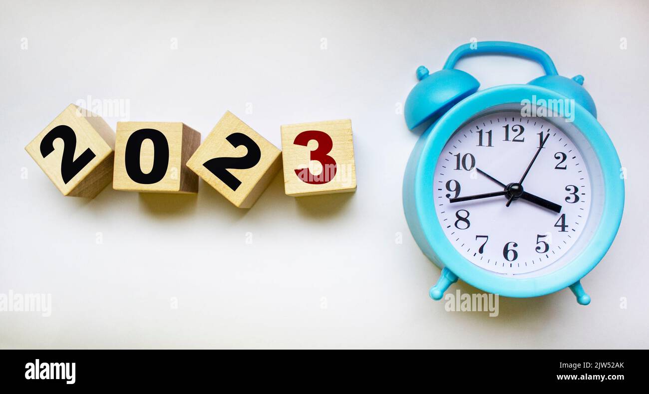 2023 New Year. On wooden cubes 2023 on a white background, next to the ...