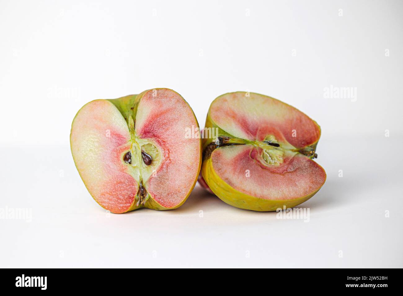 Two halves of a single lucy glo apple on a white background Stock Photo ...