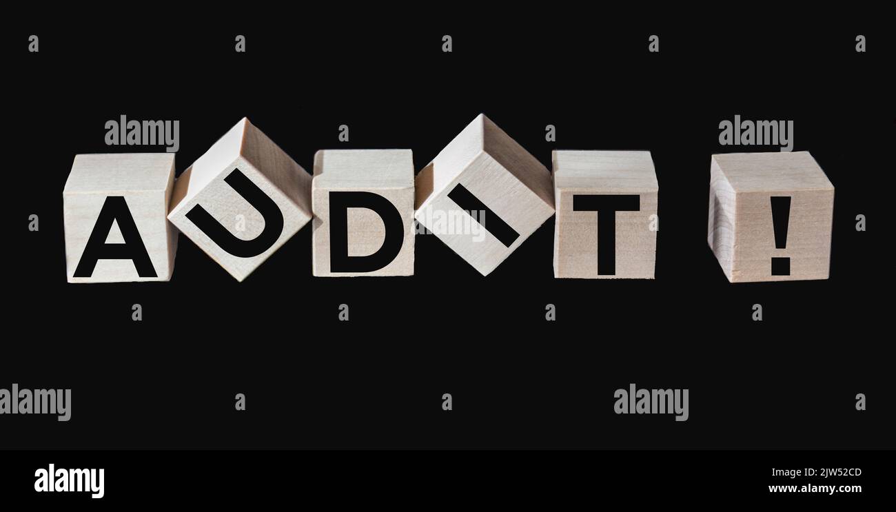 Word AUDIT text on wooden blocks and black background Stock Photo - Alamy