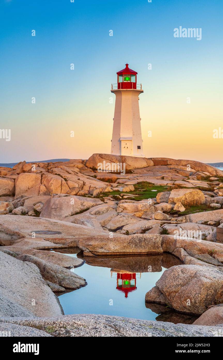 The iconic lighthouse at Peggy's Cove, Nova Scotia reflecting in a pool ...