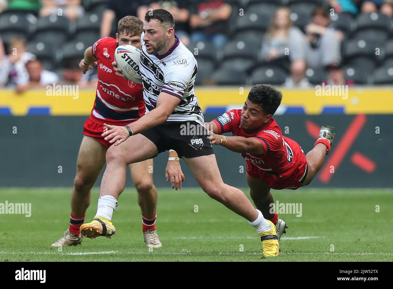 Jake Connor #1 of Hull FC gets away from Phoenix Laulu-Togaga'e #29 of ...