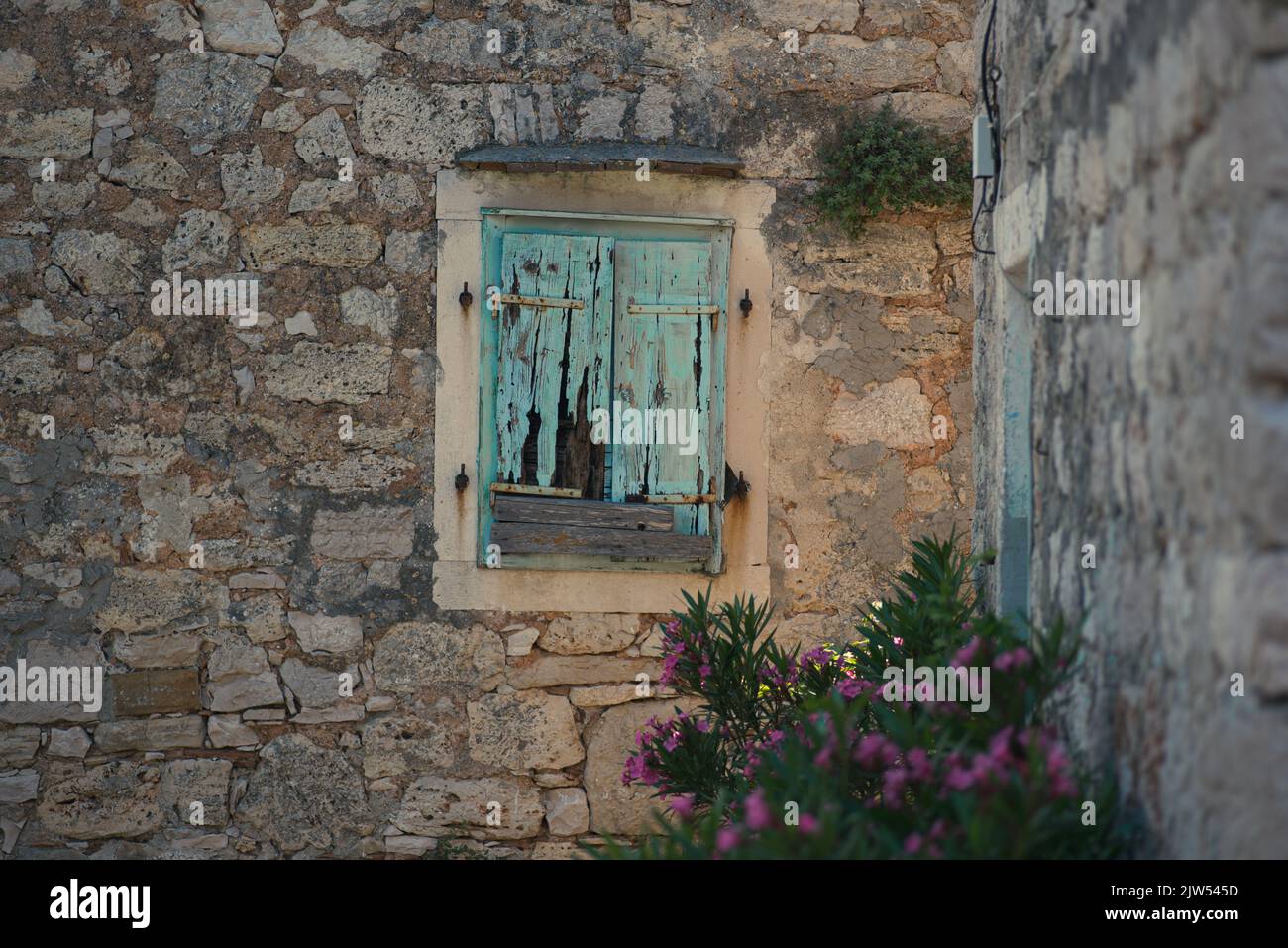 A blue broken window on an old building Stock Photo - Alamy