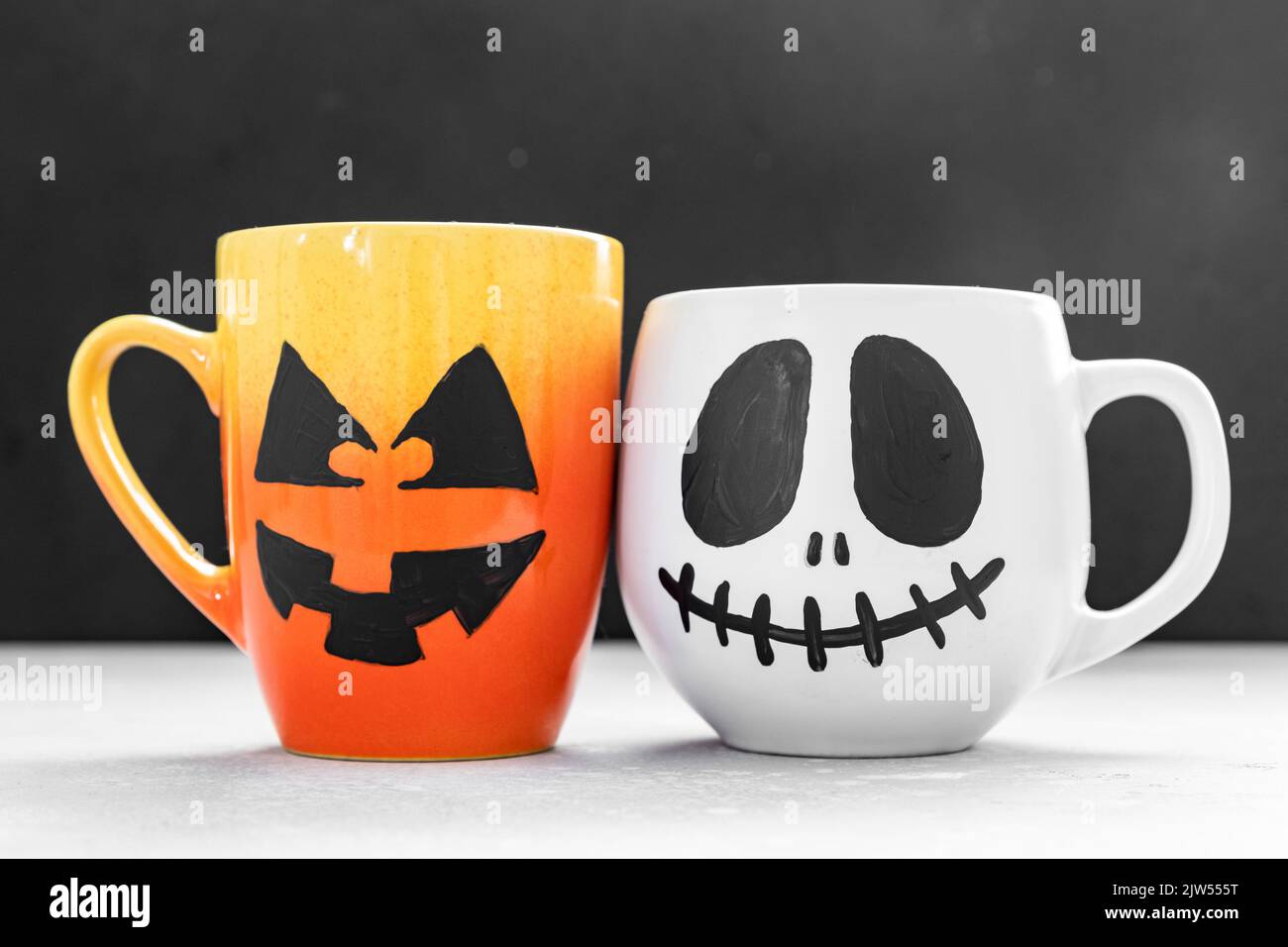 Mug with scary Jack's face. Halloween background Stock Photo - Alamy