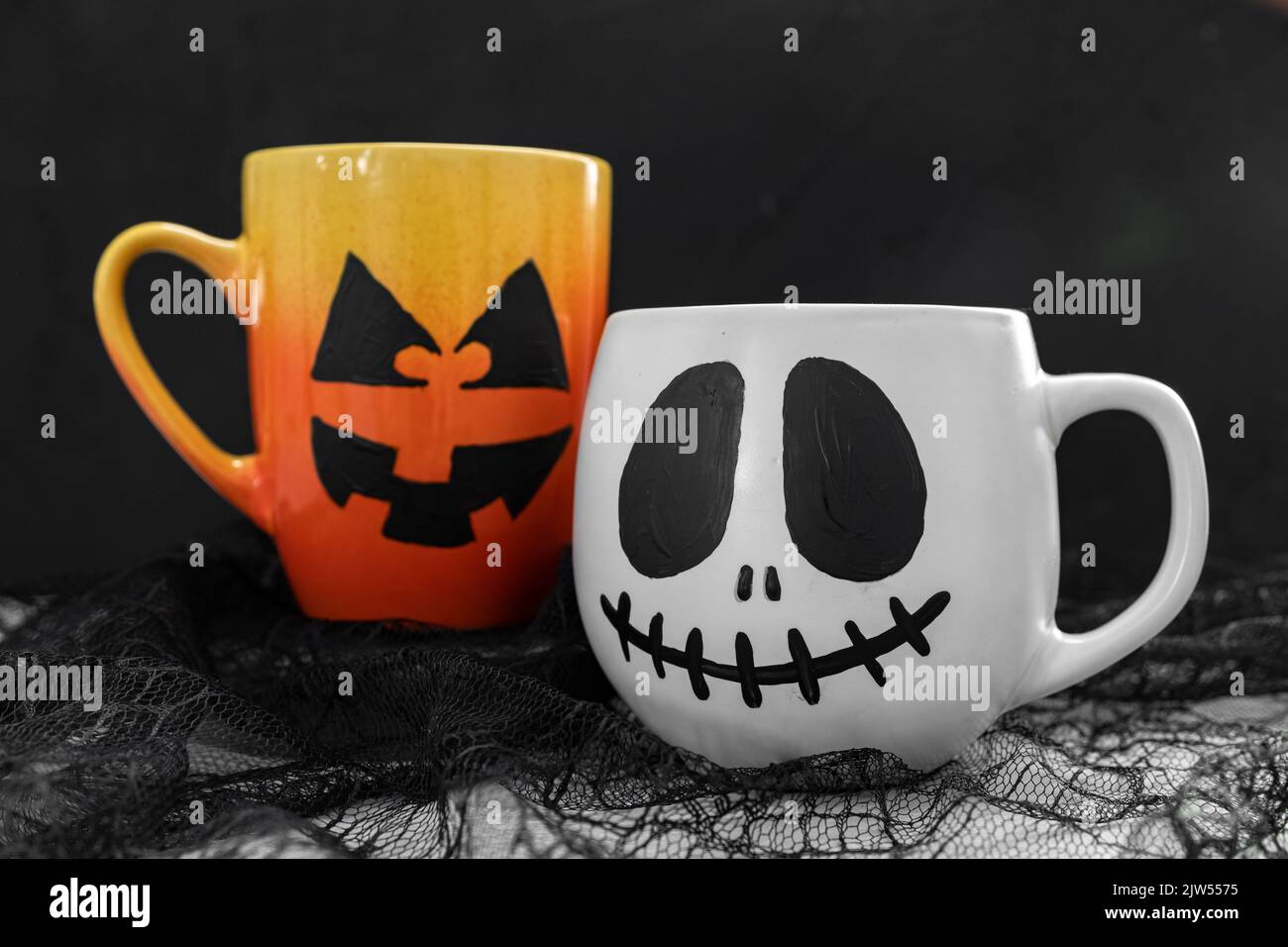 Mug with scary Jack's face. Halloween background Stock Photo - Alamy