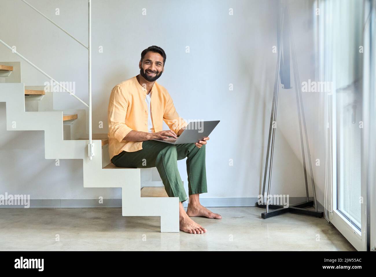Happy indian man user sitting at home using laptop remote working Stock ...