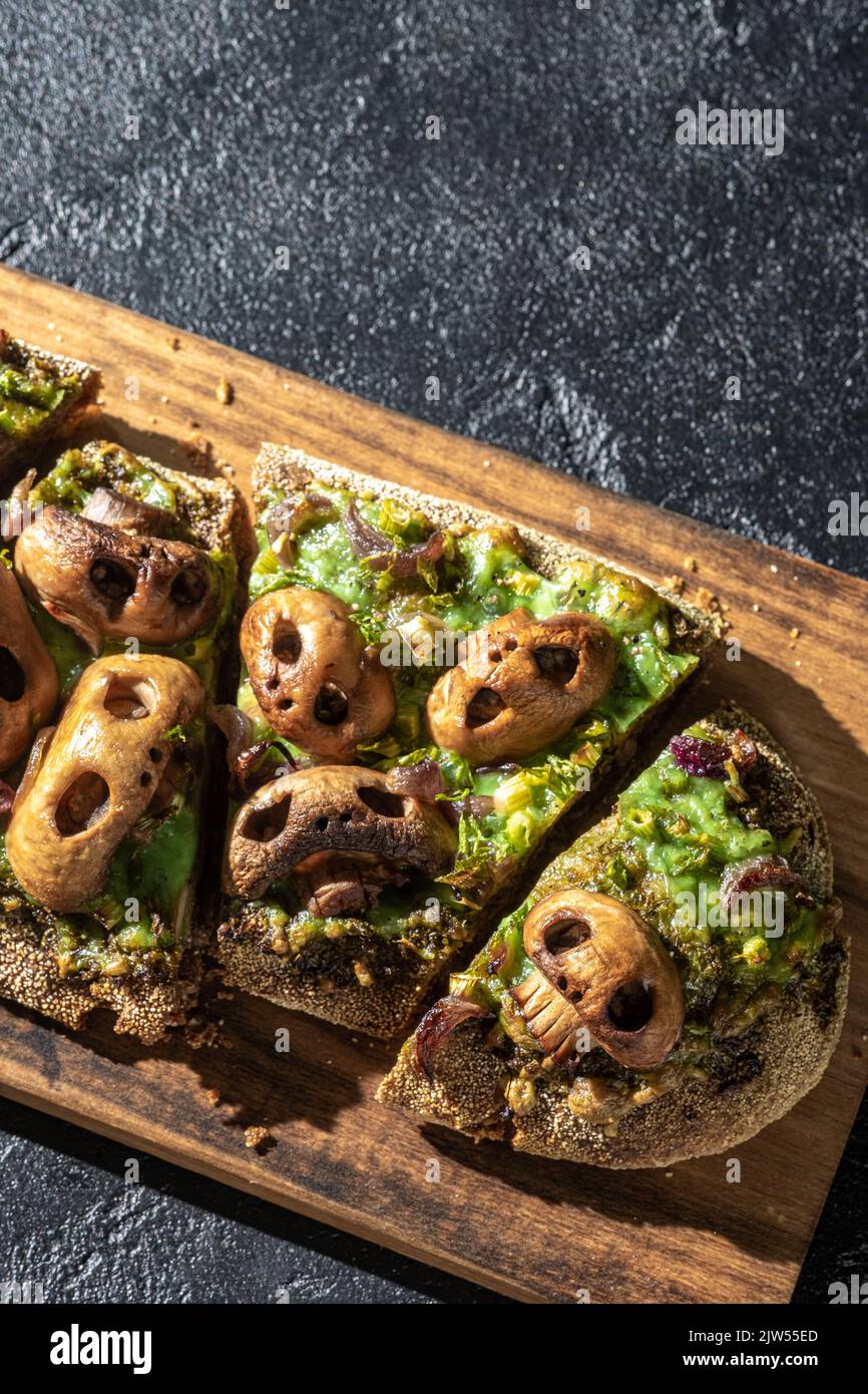 Halloween spooky pizza bread with skull-shaped mushroom Stock Photo - Alamy
