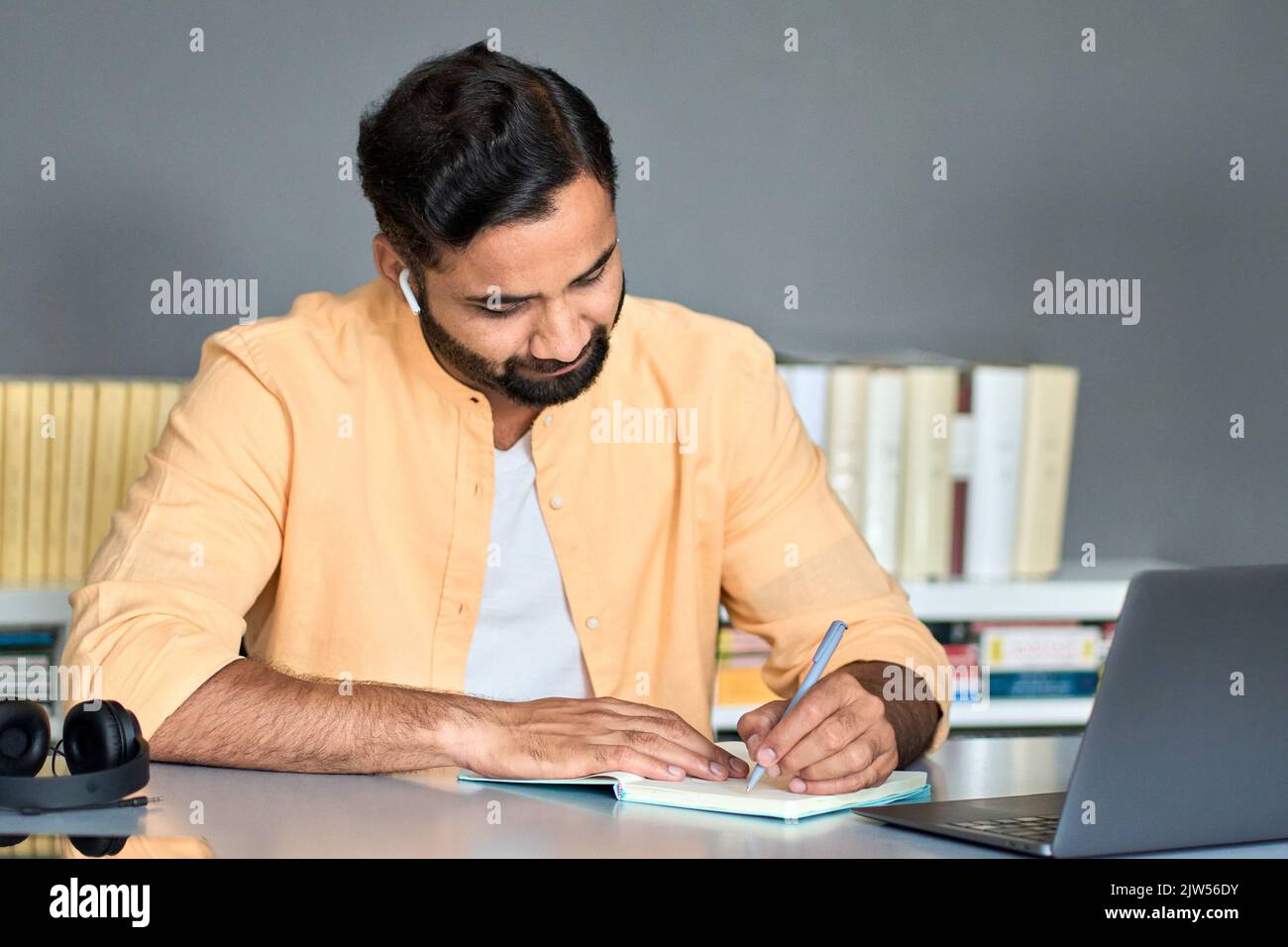 Indian business man writing notes while elearning online course webinar ...