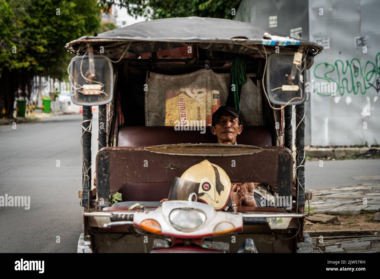 A rickshaw rider takes a break at a public park in Phnom Penh. (Photo ...