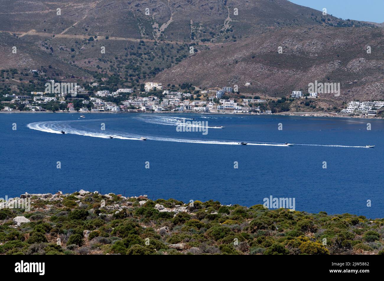 High powered boats in formation racing around Livadia Bay. Tilos island ...