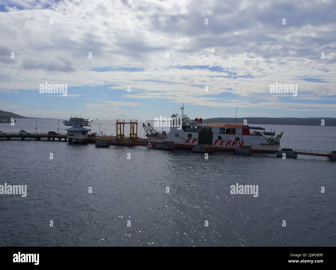 A ferry that is docked to transport passengers and vehicles across the ...