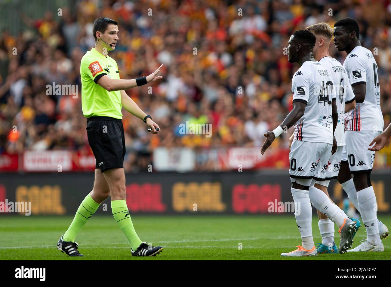Referee Brent Staessens talks to RFC Seraing players during a soccer ...