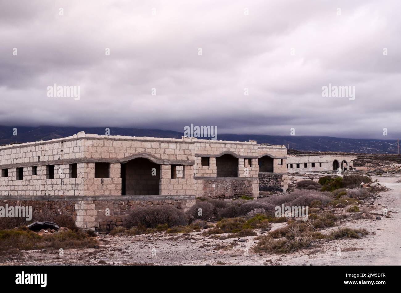 Abandoned buildings of a military base with an overcast sky in the ...