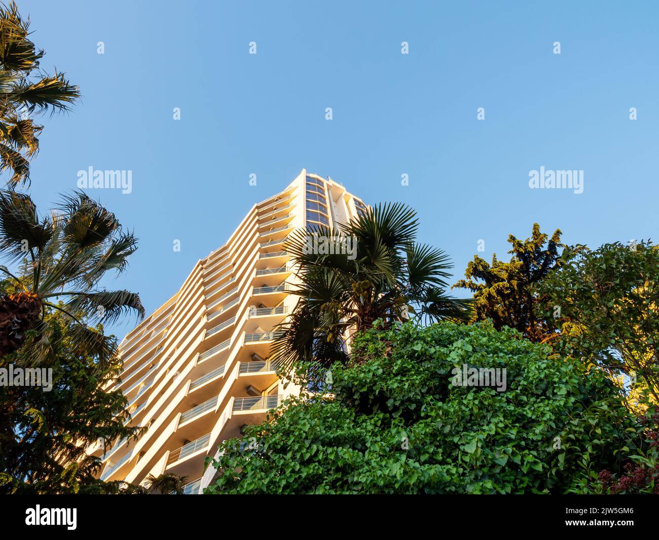 Tall building with glass balconies. Hotel complex Stock Photo - Alamy