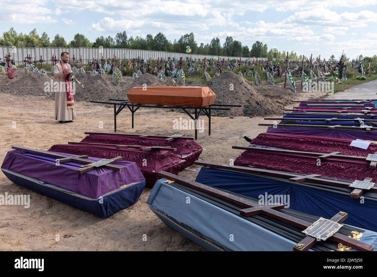 Bucha, Ukraine. 2nd Sep, 2022. A priest reads a prayer and performs a ...